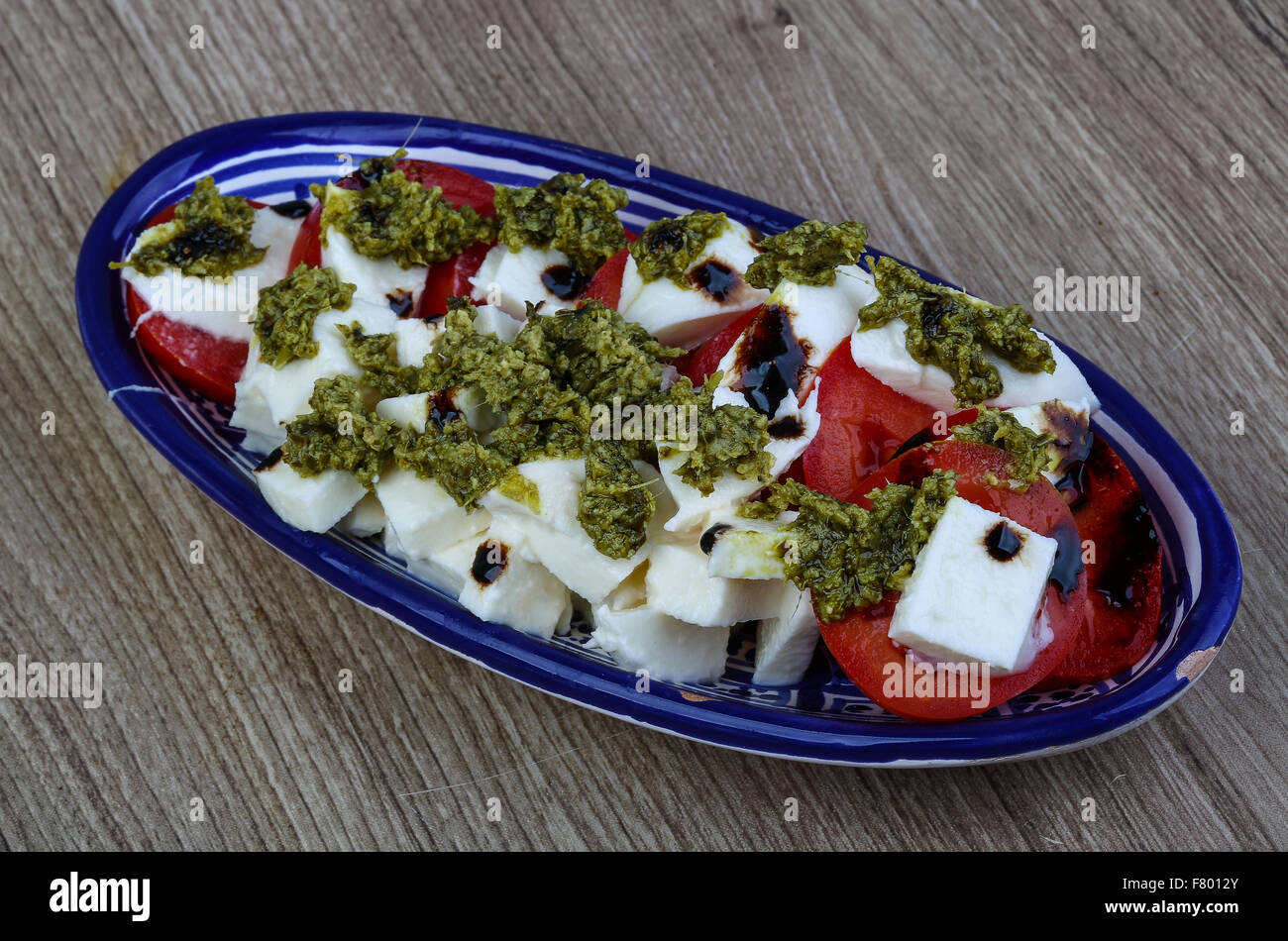 Traditional Italian Caprese salad on the wood background Stock Photo ...