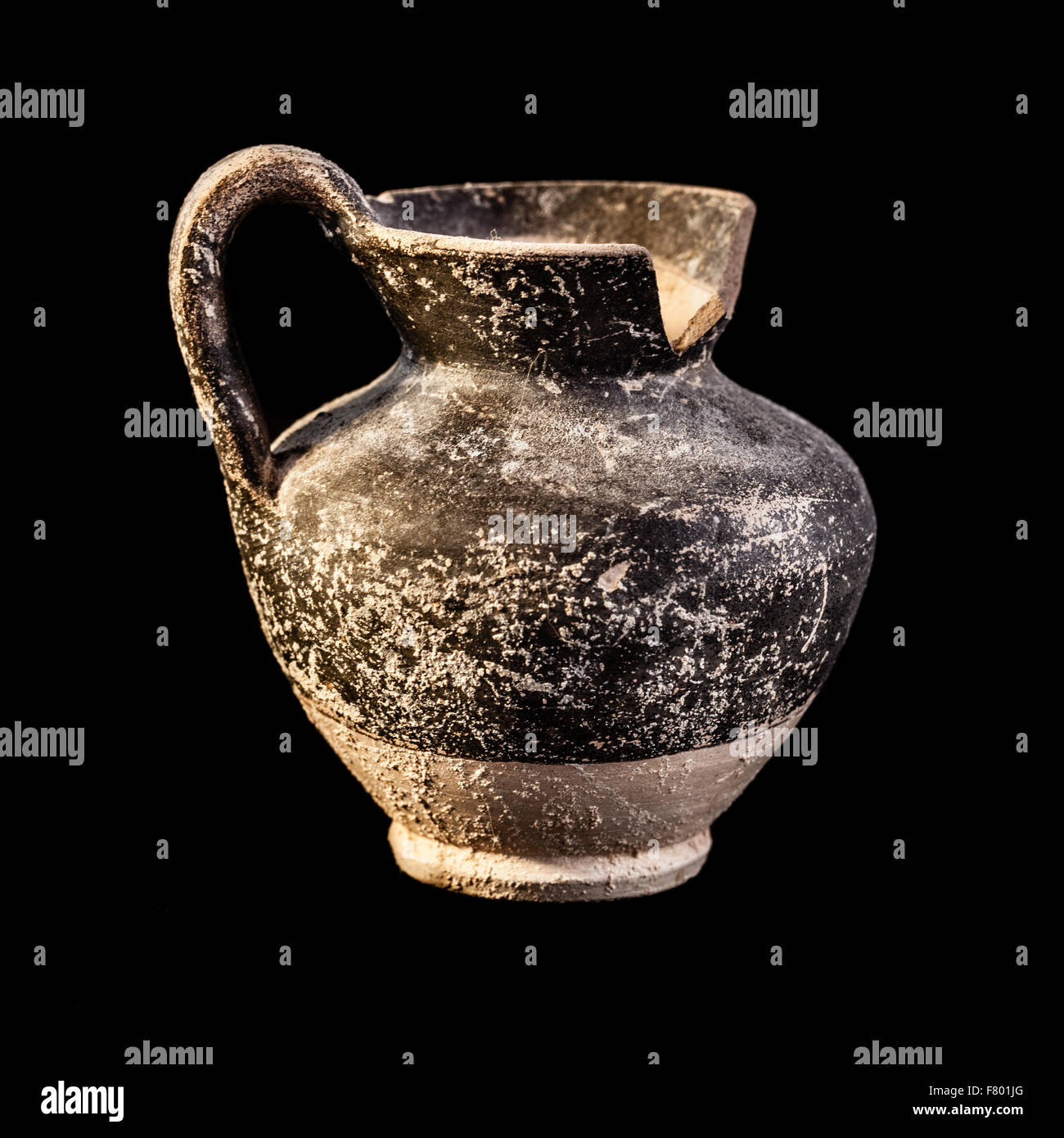 Apulian black pottery ancient canosan oenochoe isolated over a black ...