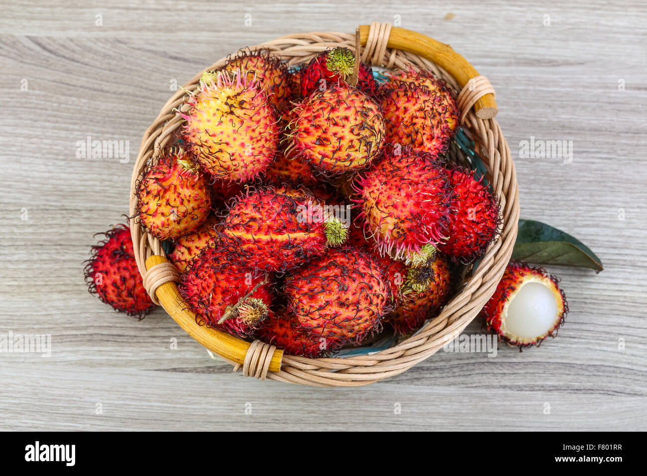 Asian fruit - rambutan - on the wood background Stock Photo - Alamy