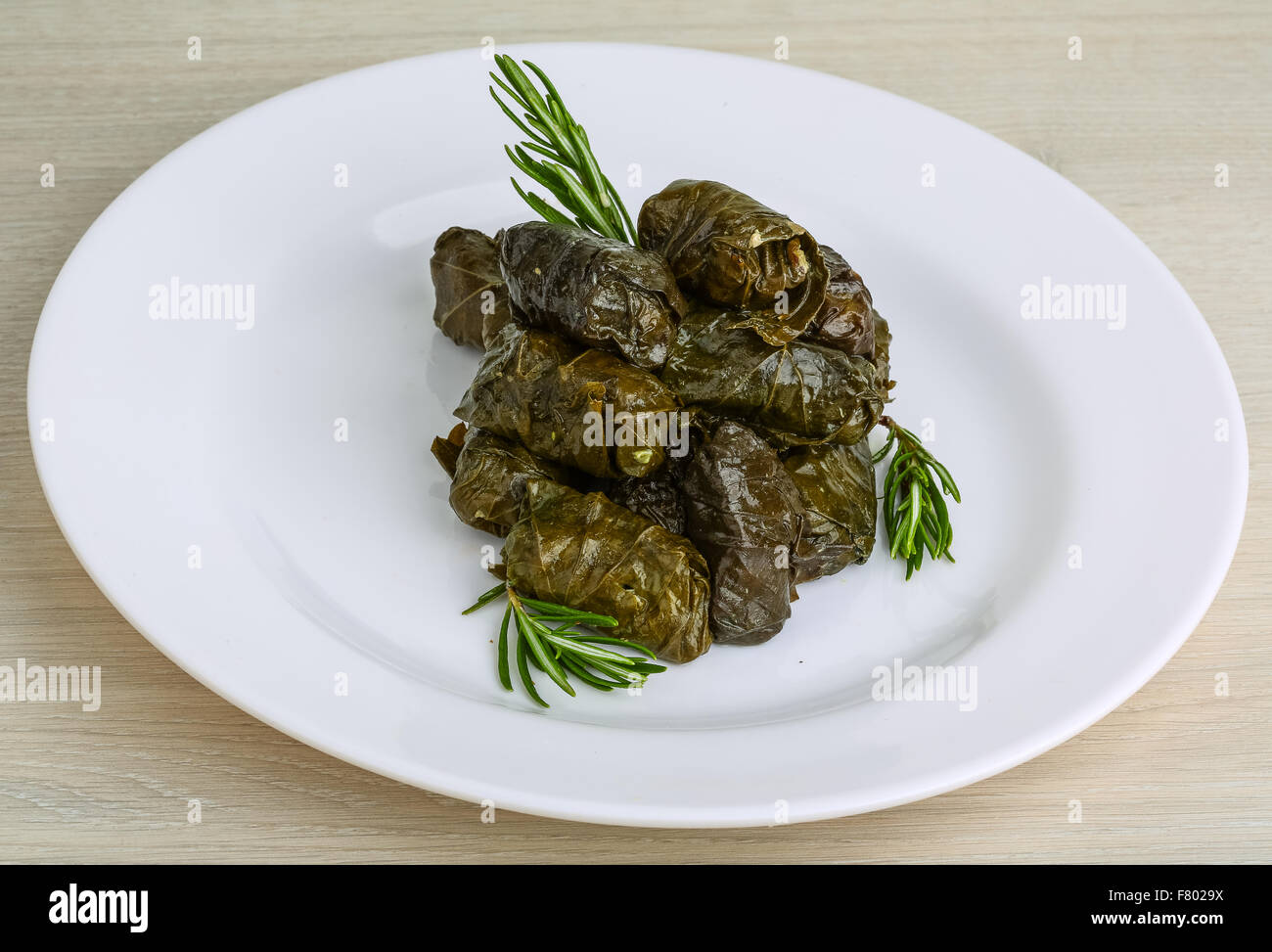 Greek dolma in grape leaves with meat served rosemary Stock Photo - Alamy