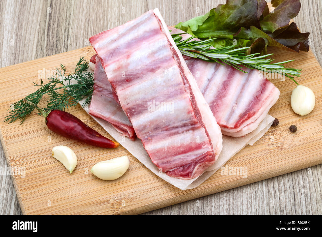 Fresh cold Raw lamb ribs with garlik and pepper - ready for cooking ...