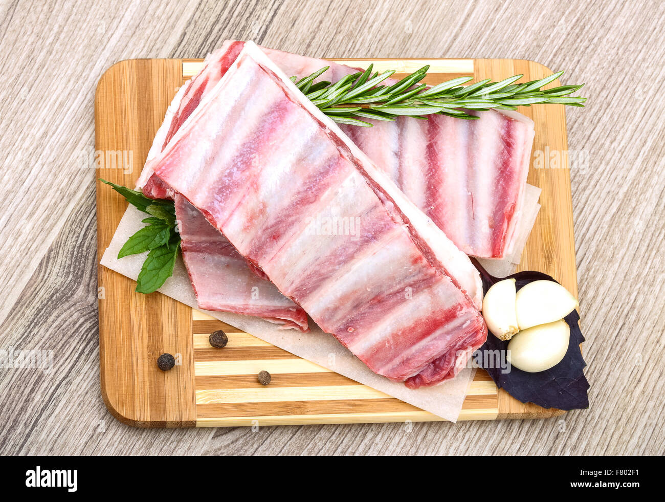 Fresh cold Raw lamb ribs with garlik and pepper - ready for cooking ...