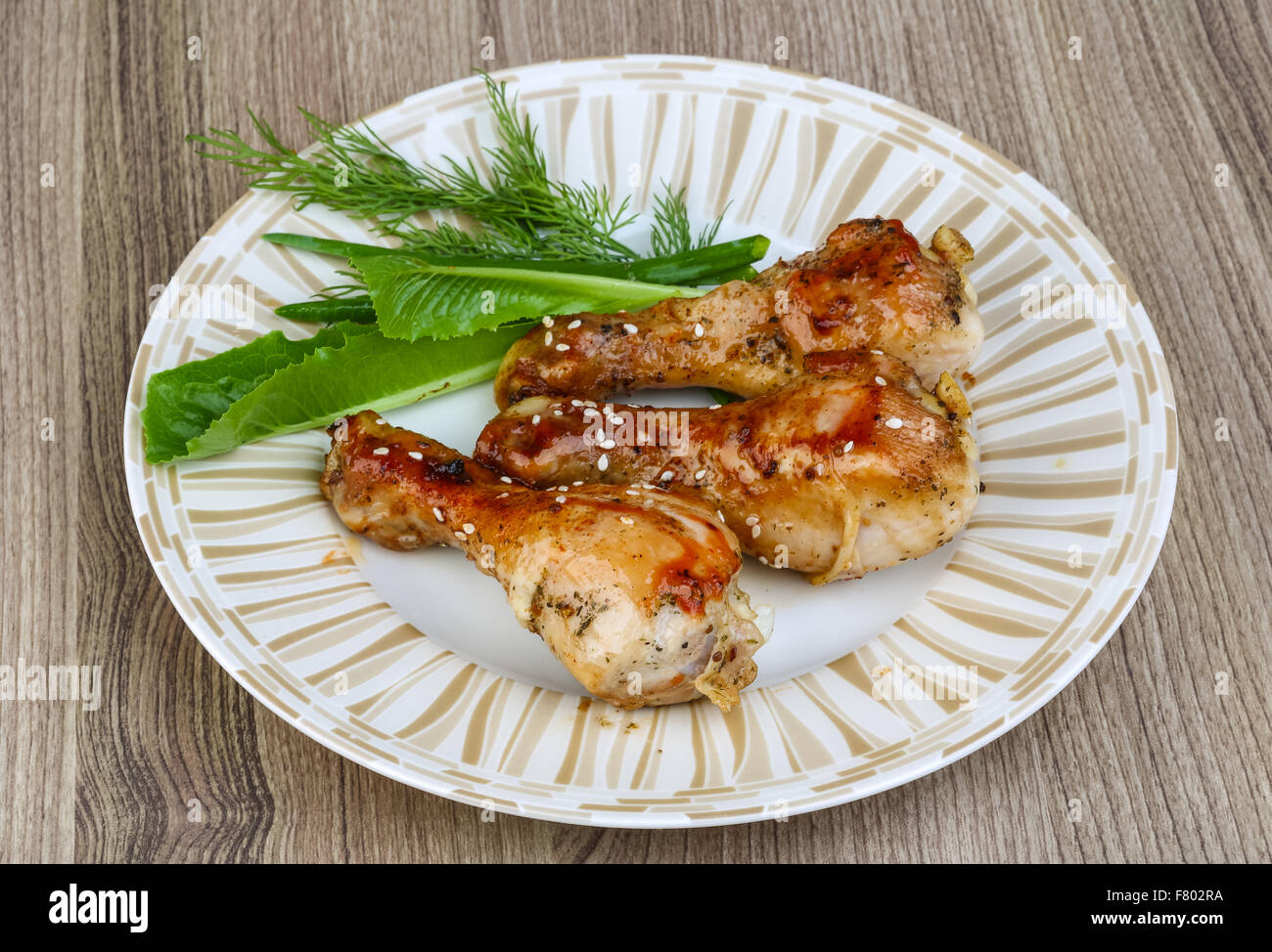 Grilled chicken legs with sesame seeds, dill and green onion Stock ...