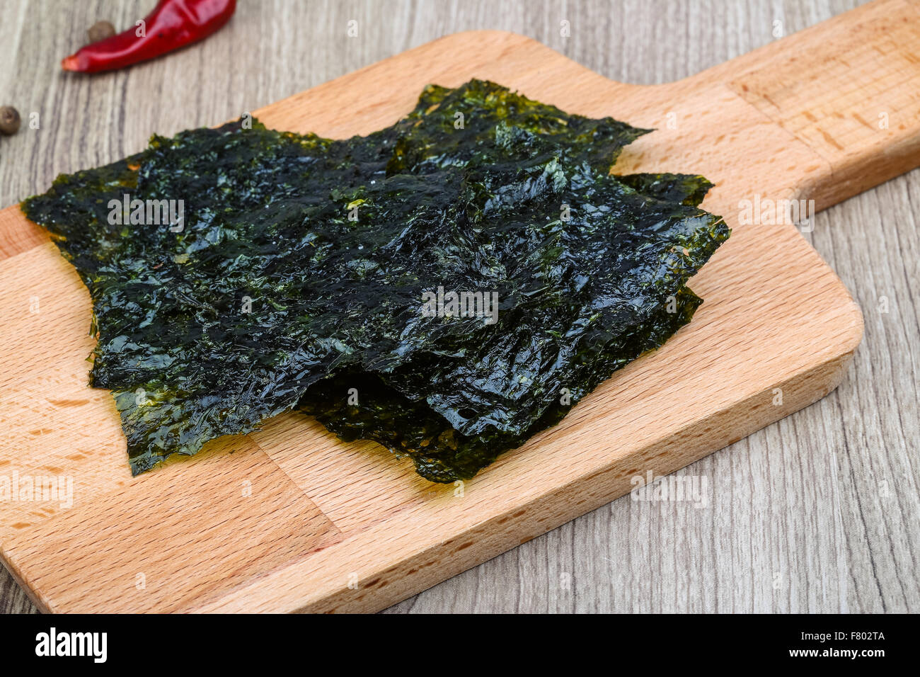 Korean traditional snack - Nori seaweed sheets on the wood background ...