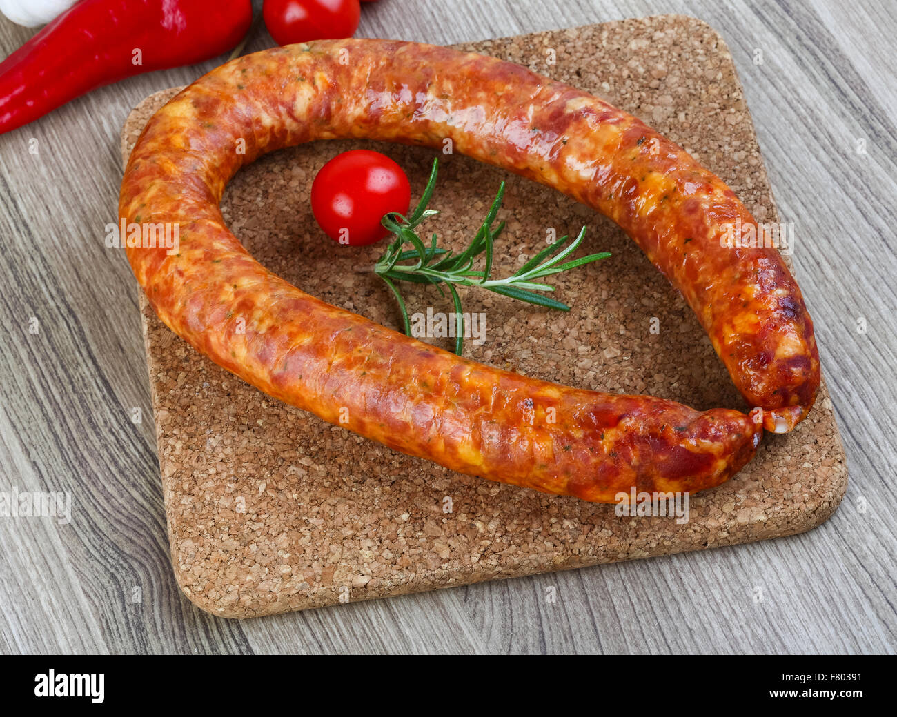 Sausage ring with rosemary and pepper on the wood background Stock ...