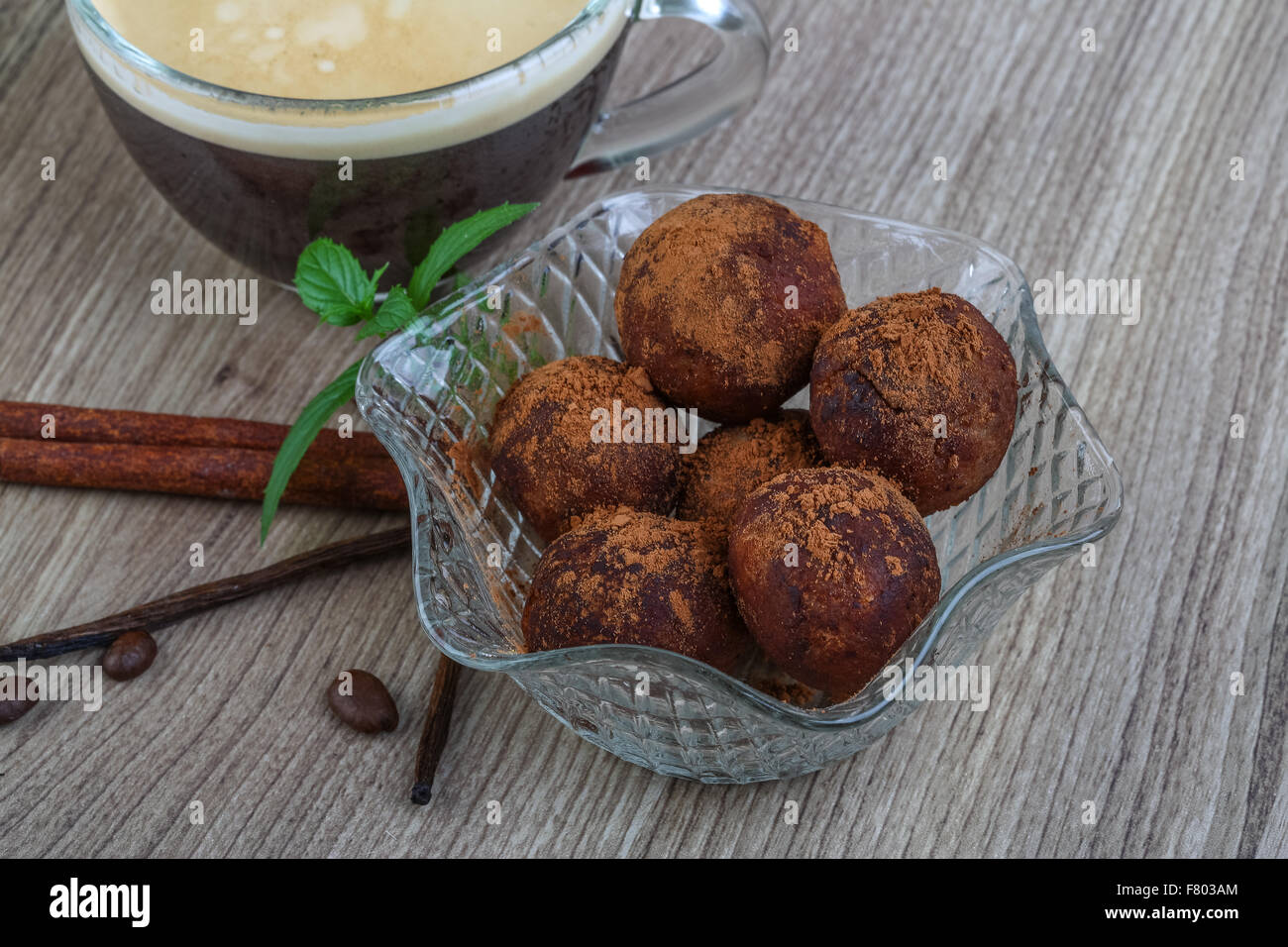 Coffee with chocolate balls served mint leaves and cinnamon sticks ...
