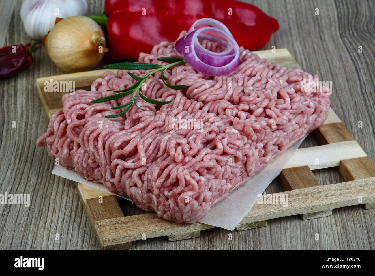 Raw minced pork meat with onion and rosemary ready for cooking Stock ...