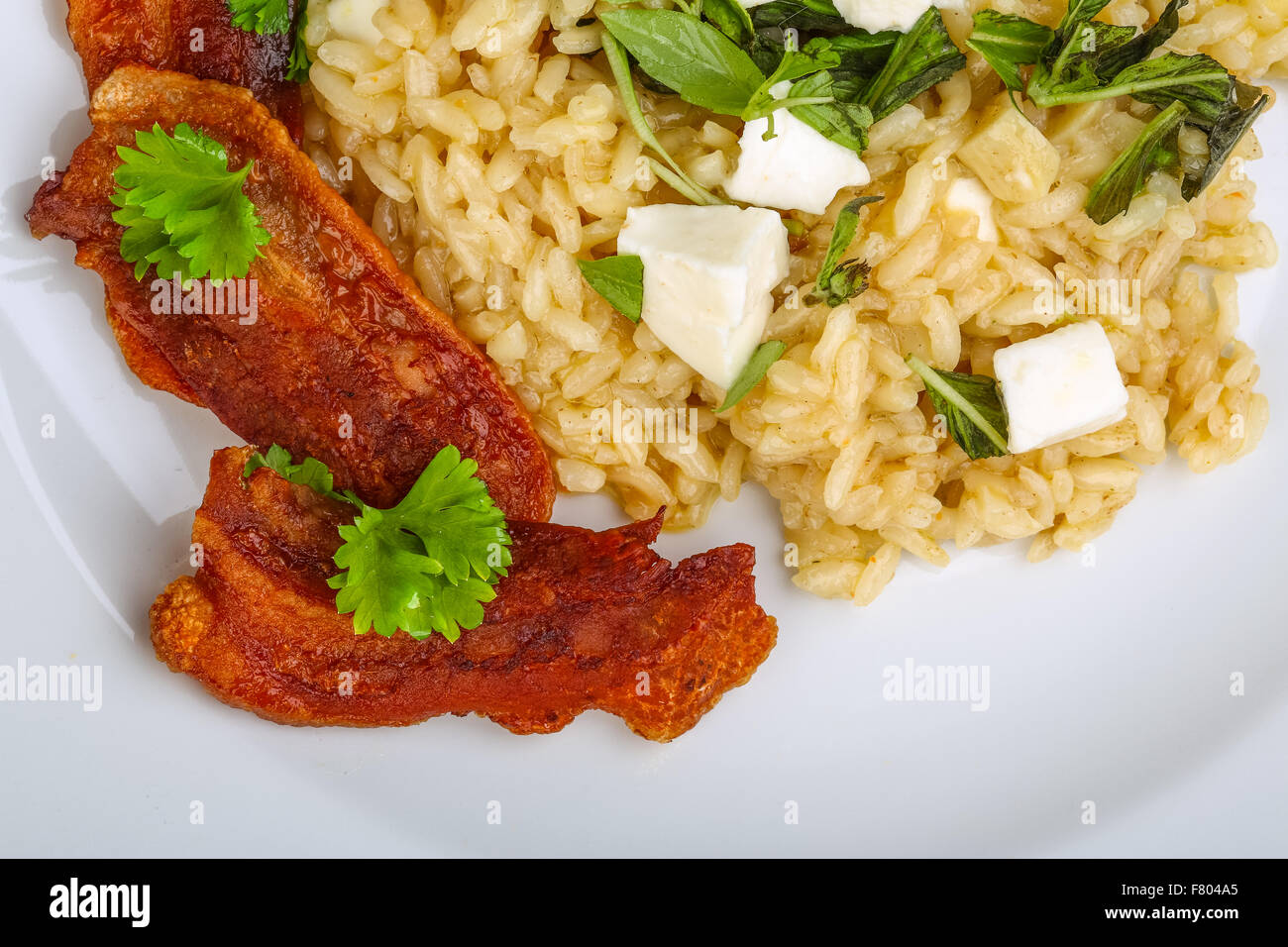 Risotto with mozzarella, basil leaves and bacon Stock Photo - Alamy