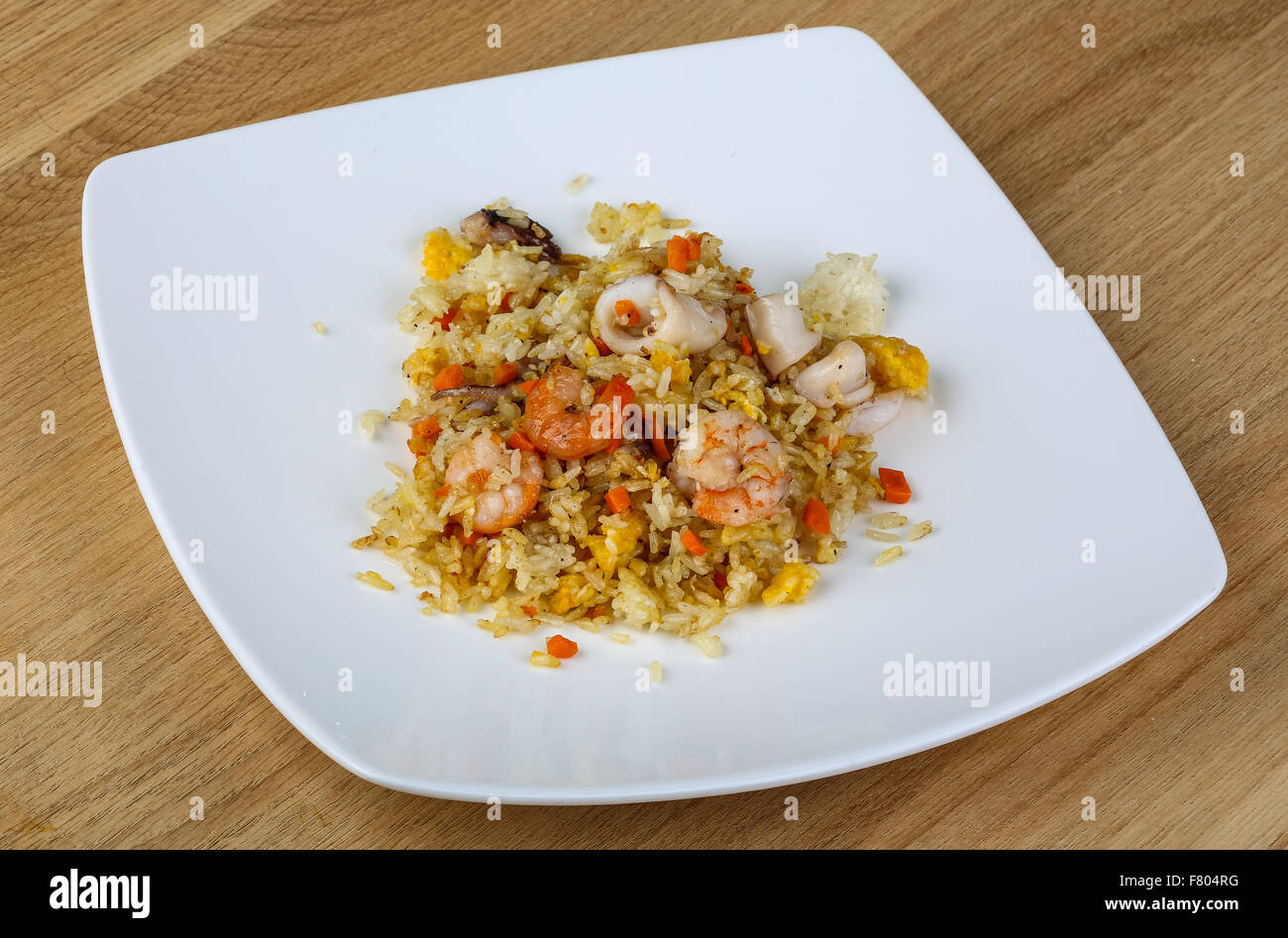 Asian traditional Fried rice with seafood on the wood background Stock ...