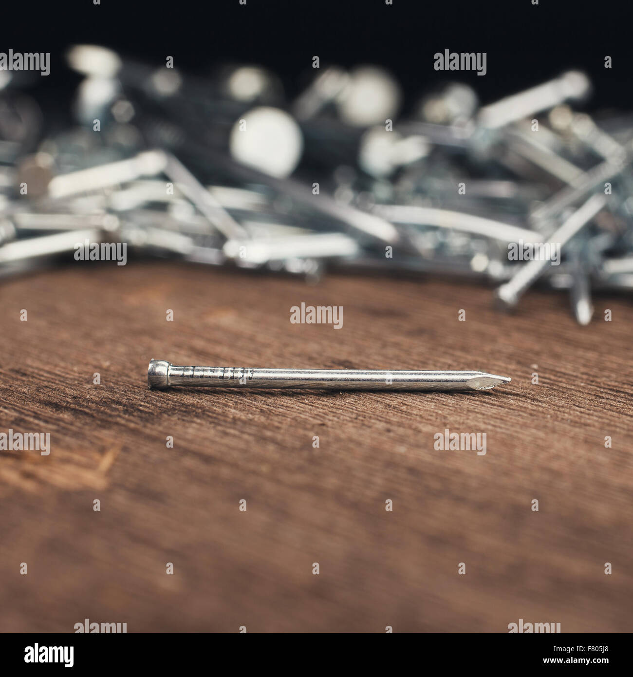 iron nails on wooden background Stock Photo - Alamy