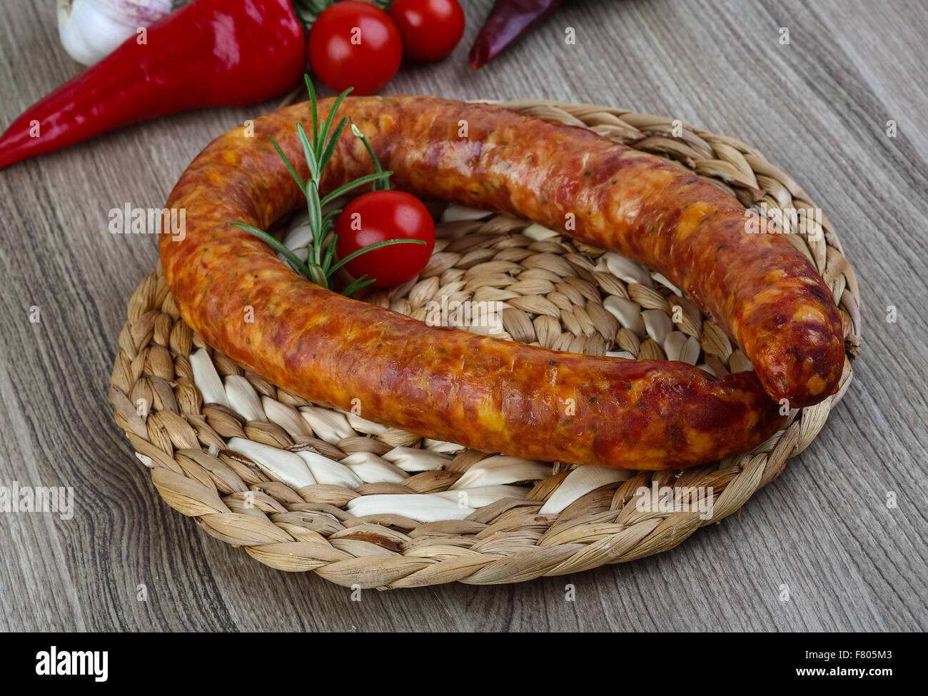 Sausage ring with rosemary and pepper on the wood background Stock ...