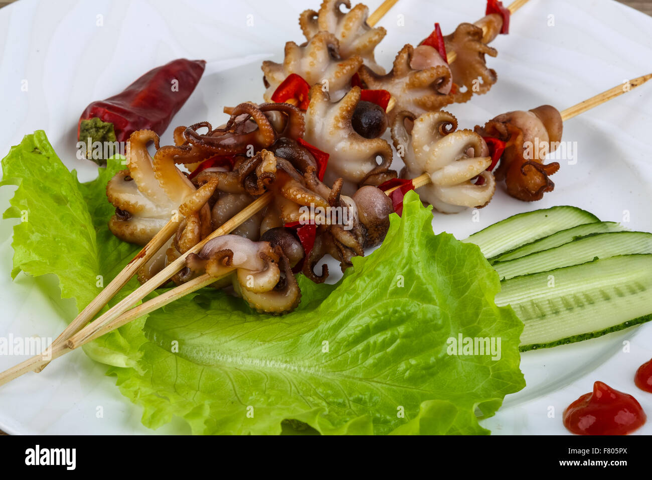 Barbecue baby octopus with bell pepper and spices Stock Photo - Alamy