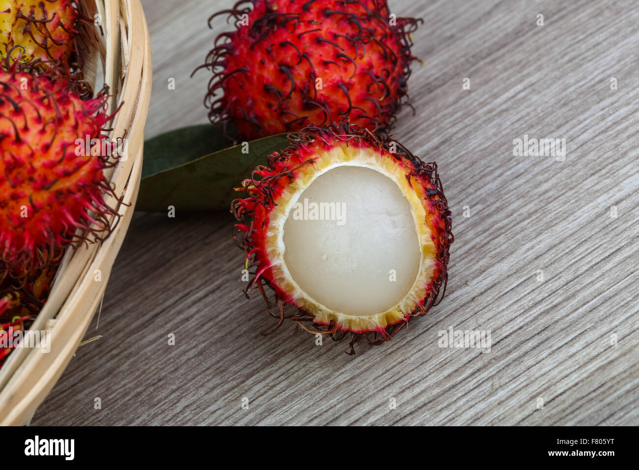 Asian fruit - rambutan - on the wood background Stock Photo - Alamy