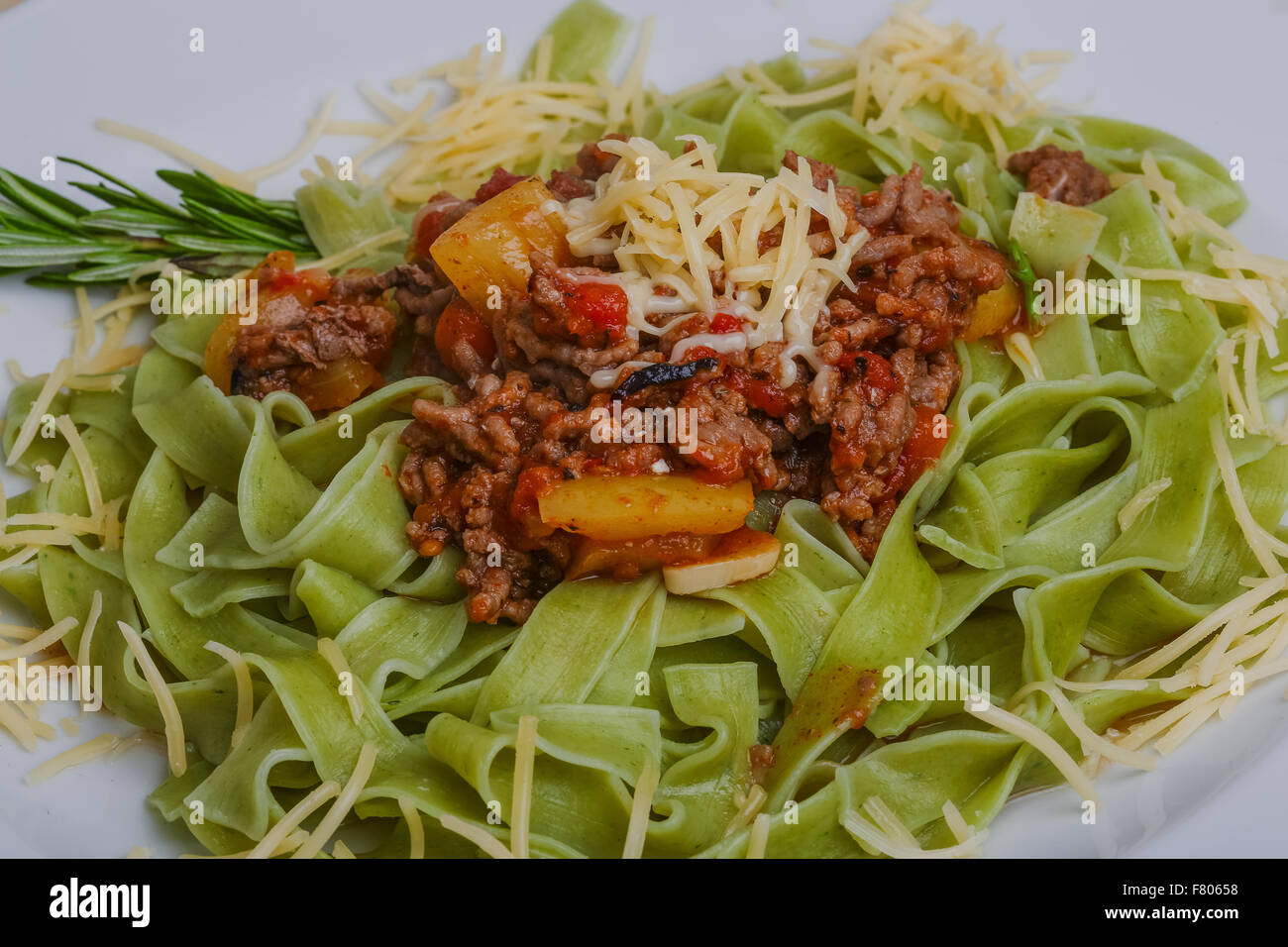 Green pasta Bolognese with rosemary and parmesan cheese Stock Photo - Alamy