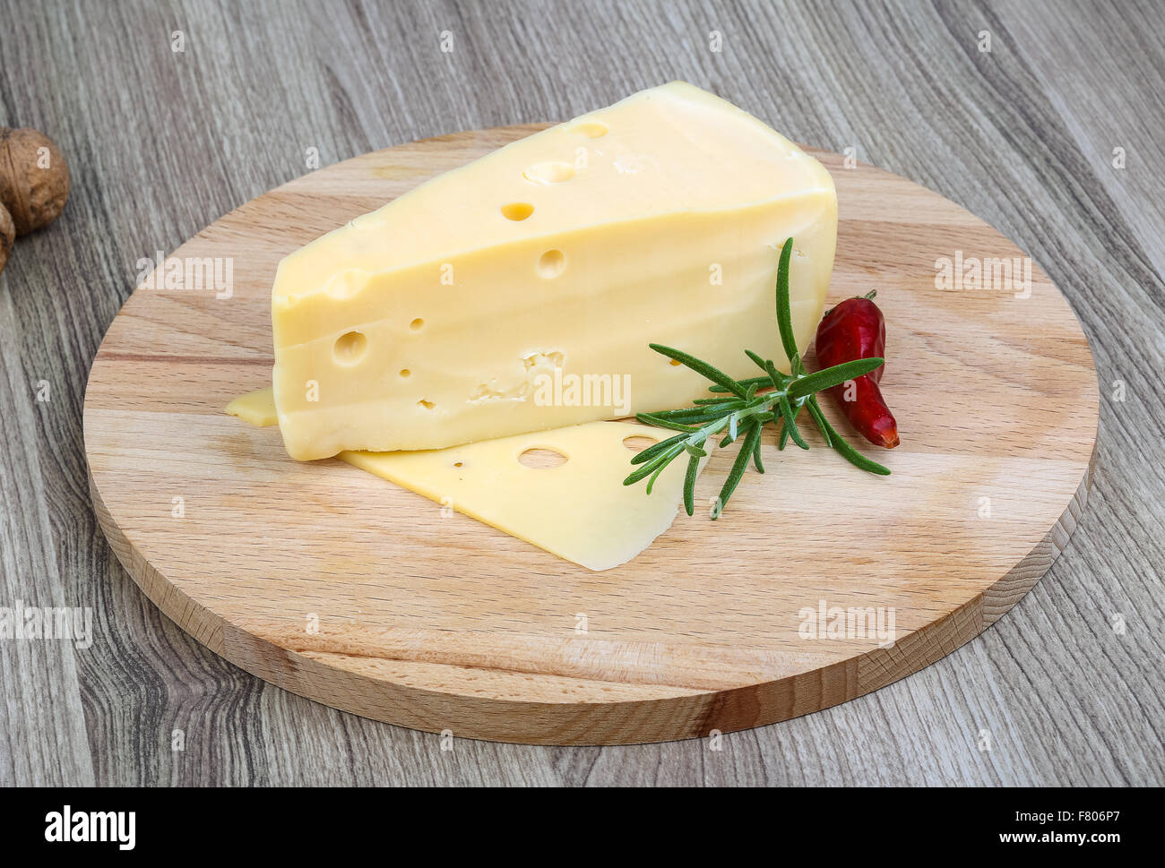 Triangle yellow cheese with rosemary, pepper and salad leaves Stock ...