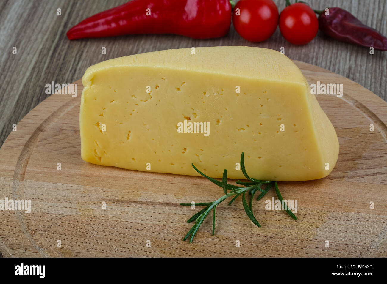 Yellow cheese triangle with rosemary herbs on the wood background Stock ...