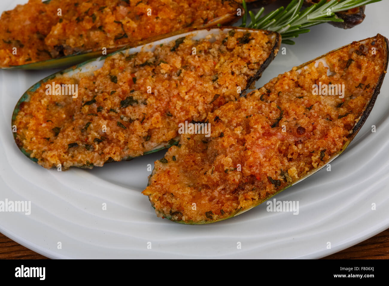 Baked mussels with bread and spices served rosemary Stock Photo - Alamy