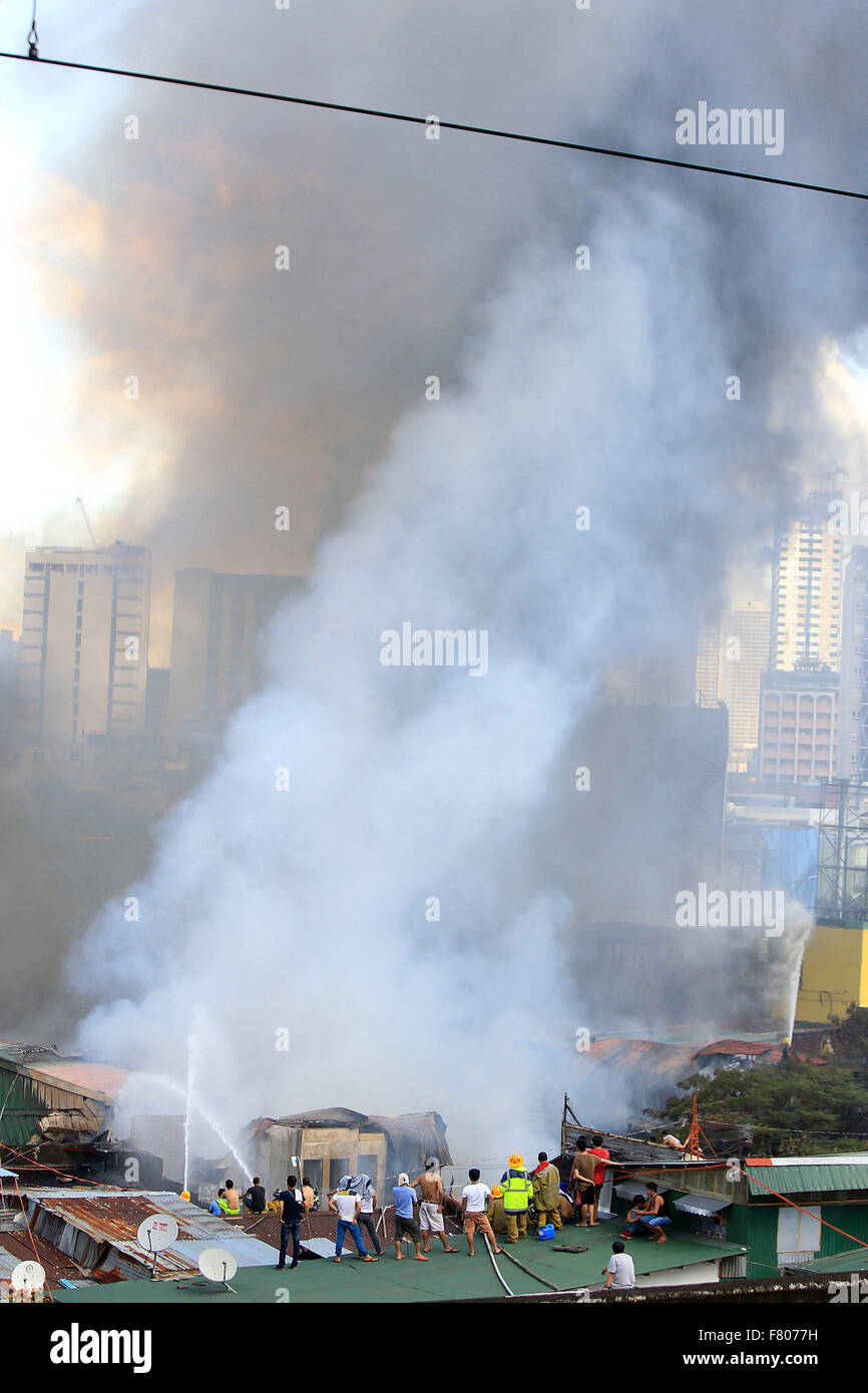 Manila, Philippines. 4th Dec, 2015. Smoke billows from a fire at a slum ...
