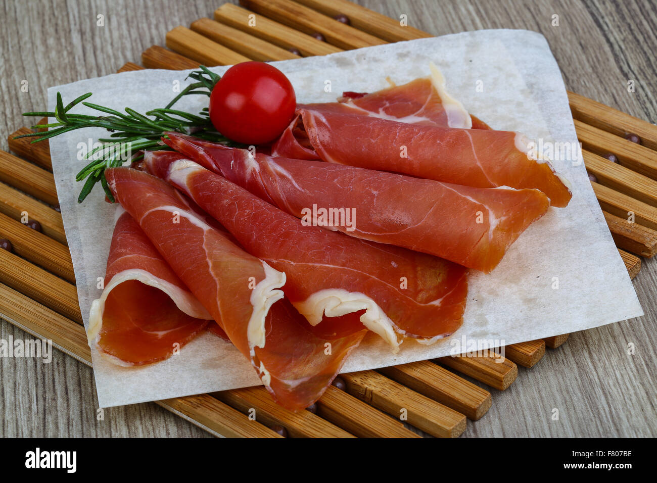 Spanish traditional snack - Jamon with tomato and rosemary Stock Photo ...