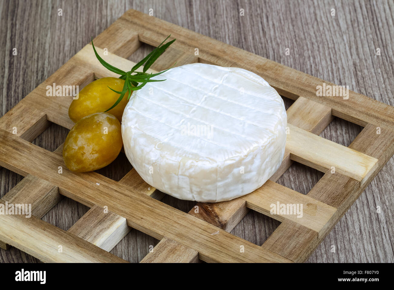 Round Brie cheese with yellow plums and estragon Stock Photo - Alamy