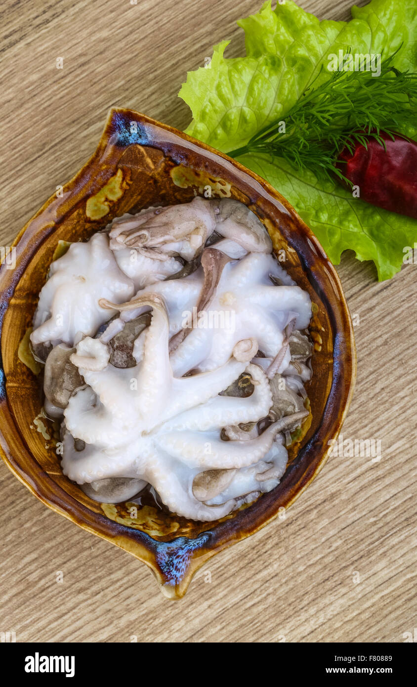 Raw baby octopus in the bowl ready for cooking Stock Photo - Alamy