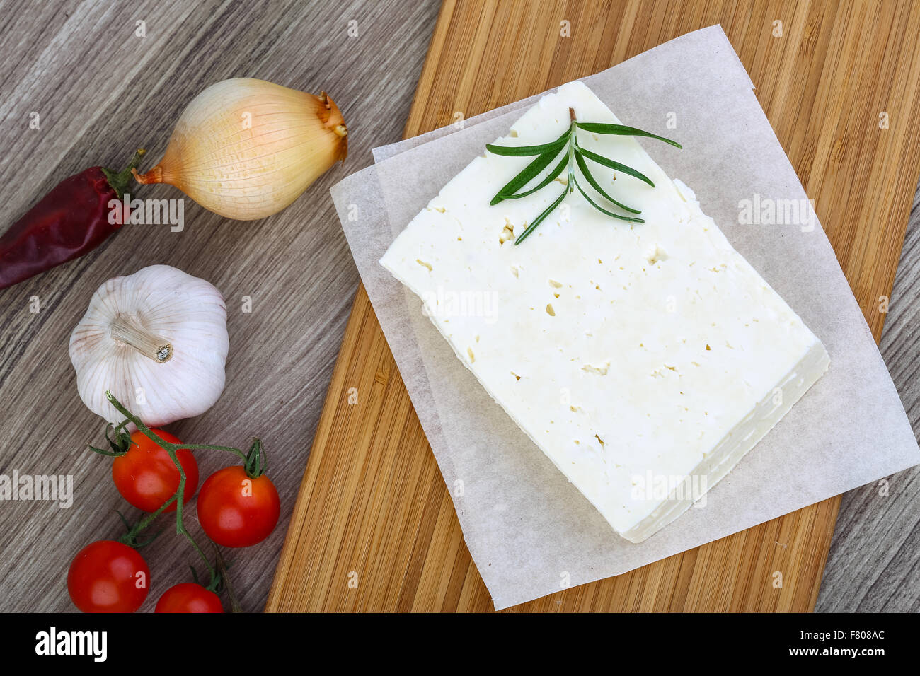 Traditional Caucasian homemade Cheese Brinza with rosemary on wood ...