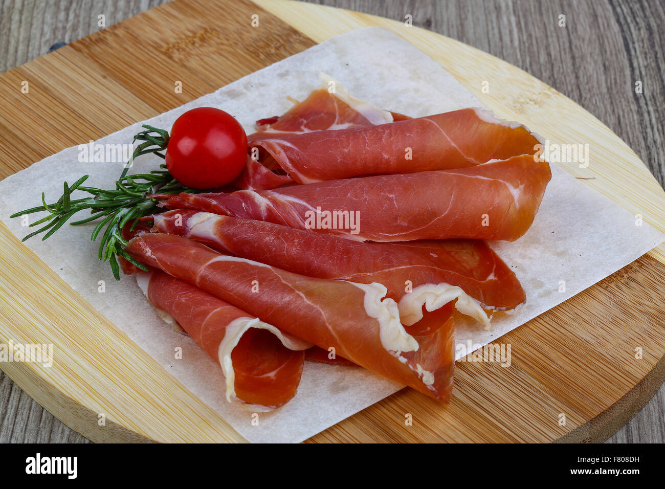 Spanish traditional snack - Jamon with tomato and rosemary Stock Photo ...