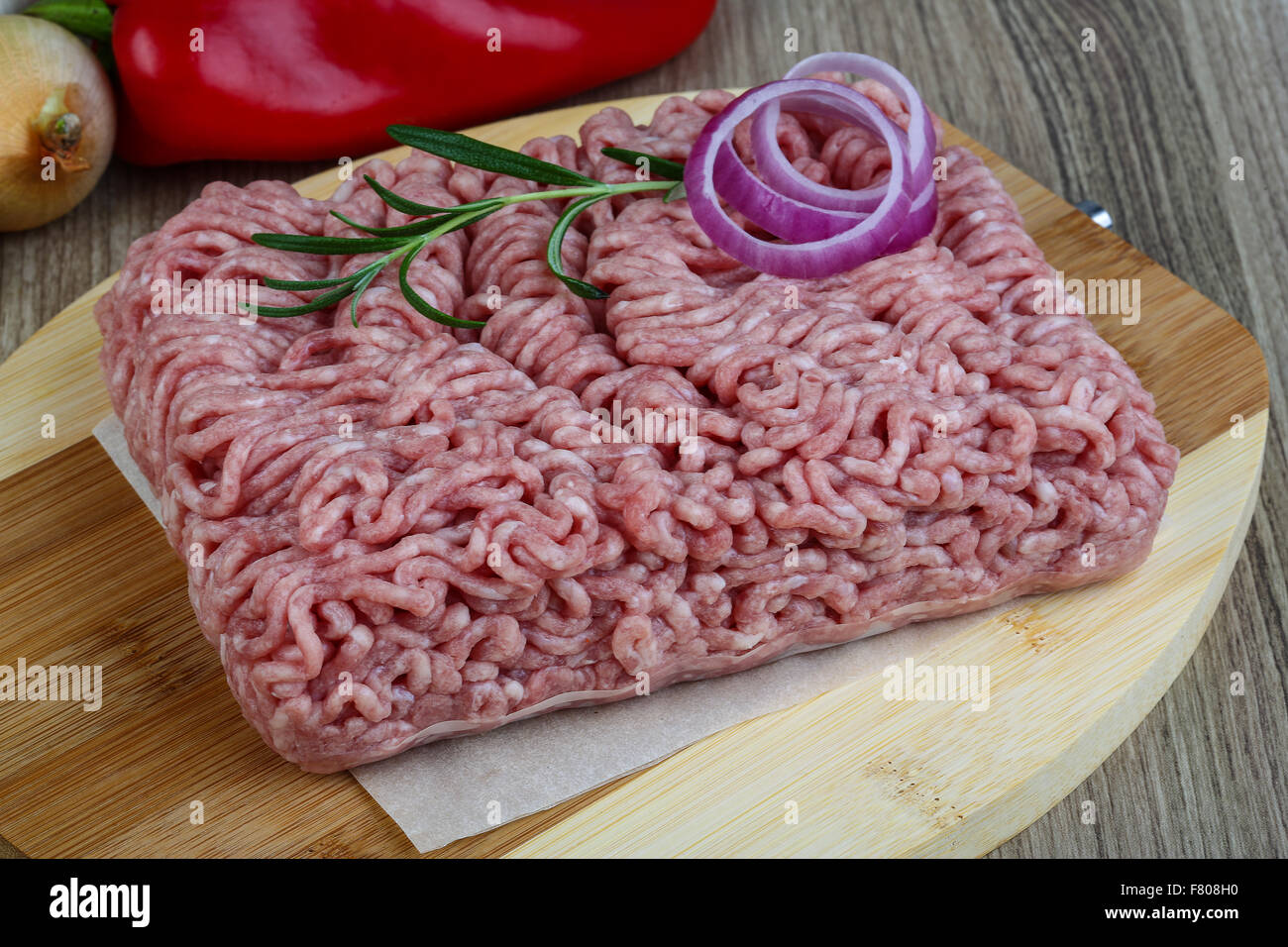 Raw minced pork meat with onion and rosemary ready for cooking Stock ...