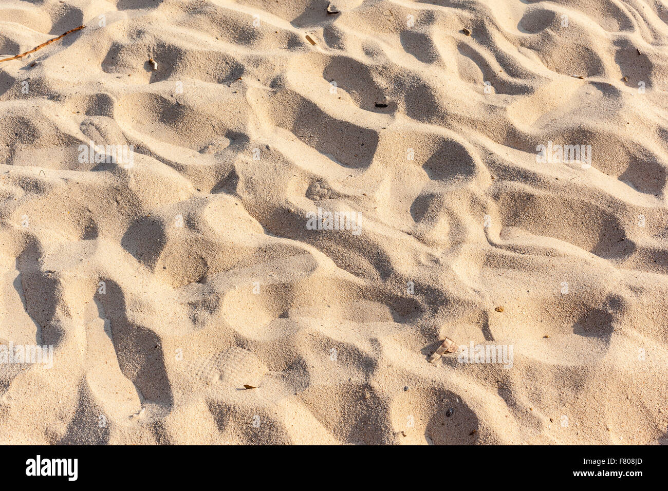 close up shot of the clean sand on a tropical island with footprints ...