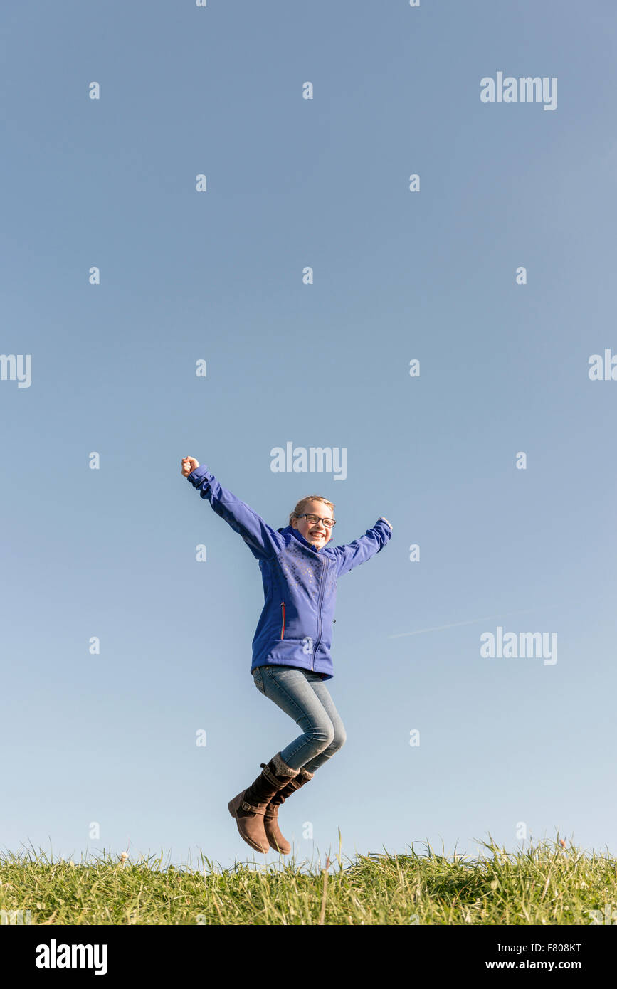 Happy girl jumping blue sky hi-res stock photography and images - Alamy