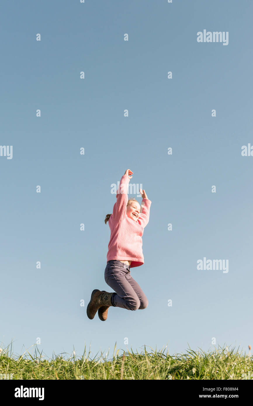 Happy girl jumping blue sky hi-res stock photography and images - Alamy