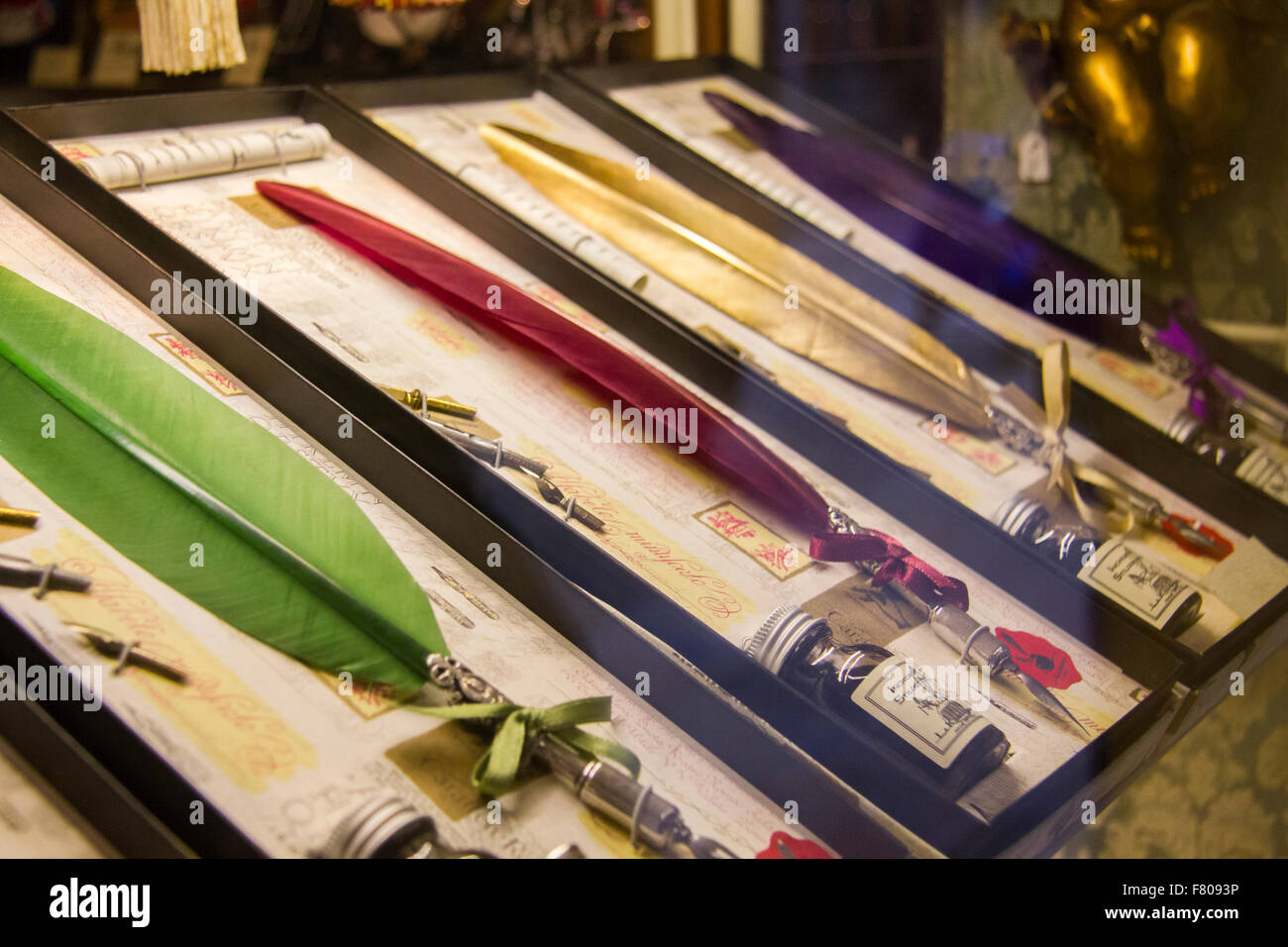 Old fashioned colored feather pens with black ink in antique black box ...