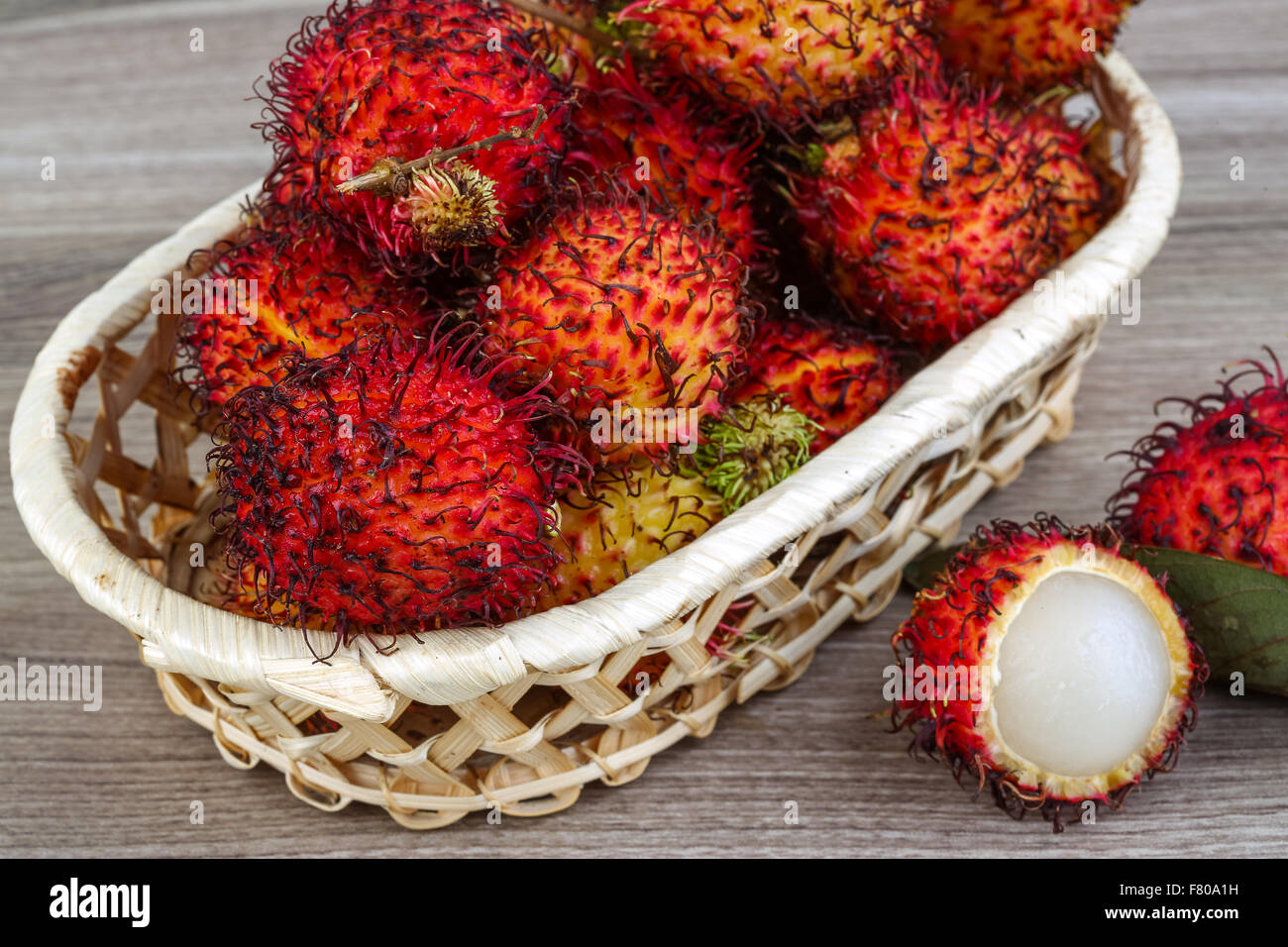 Asian fruit - rambutan - on the wood background Stock Photo - Alamy