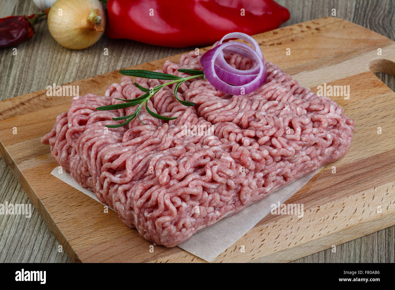 Raw minced pork meat with onion and rosemary ready for cooking Stock ...