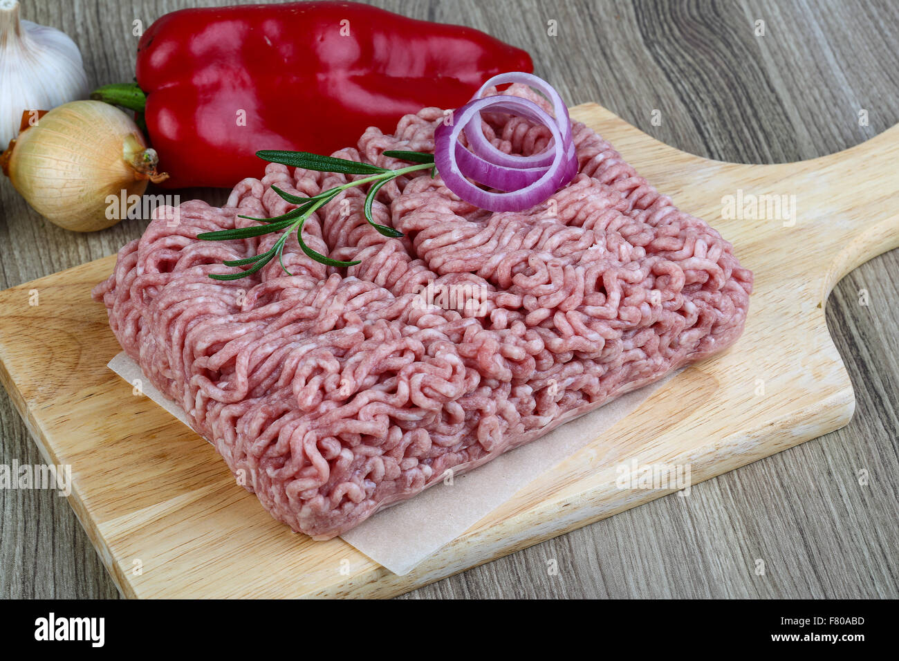 Raw minced pork meat with onion and rosemary ready for cooking Stock ...
