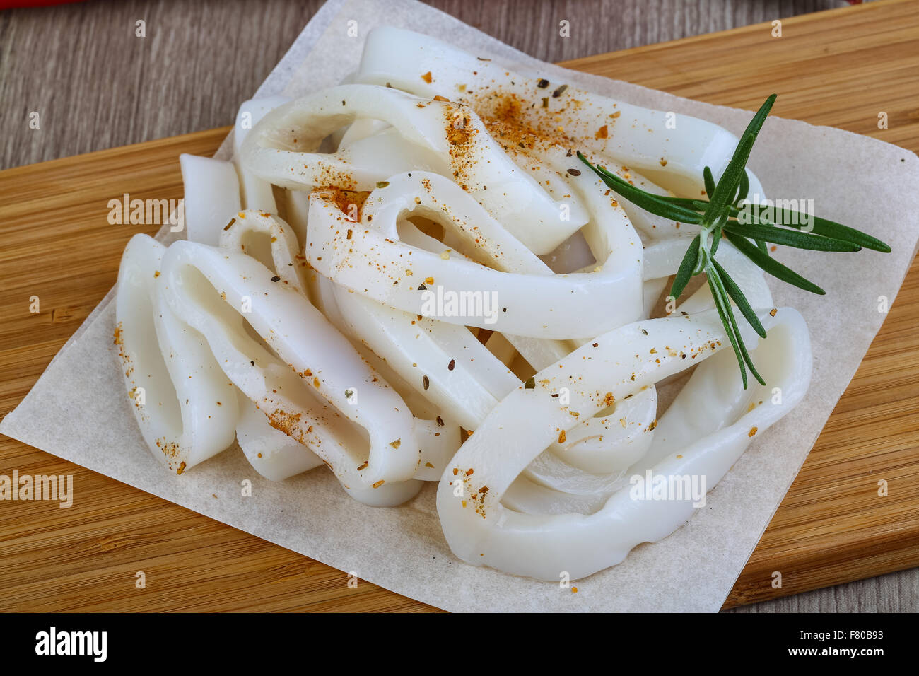 Raw squid rings with herbs - ready for cooking Stock Photo - Alamy