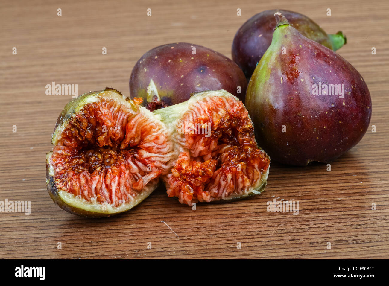 Fresh ripe Figs on the wood background Stock Photo - Alamy