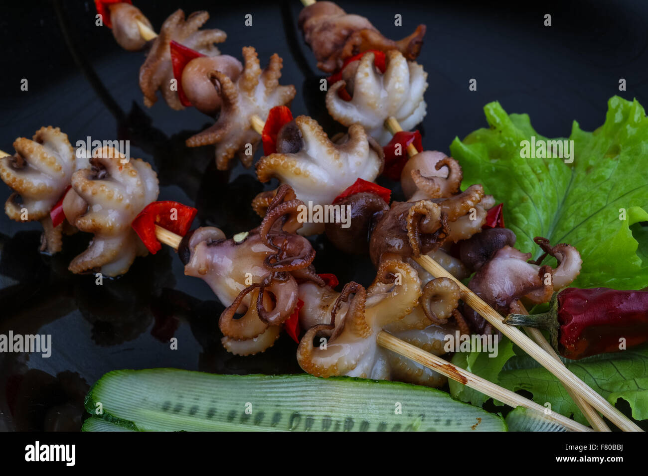 Barbecue baby octopus with bell pepper and spices Stock Photo - Alamy