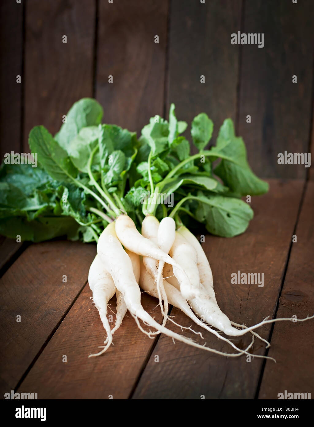 Fresh daikon radish on a wooden background Stock Photo - Alamy