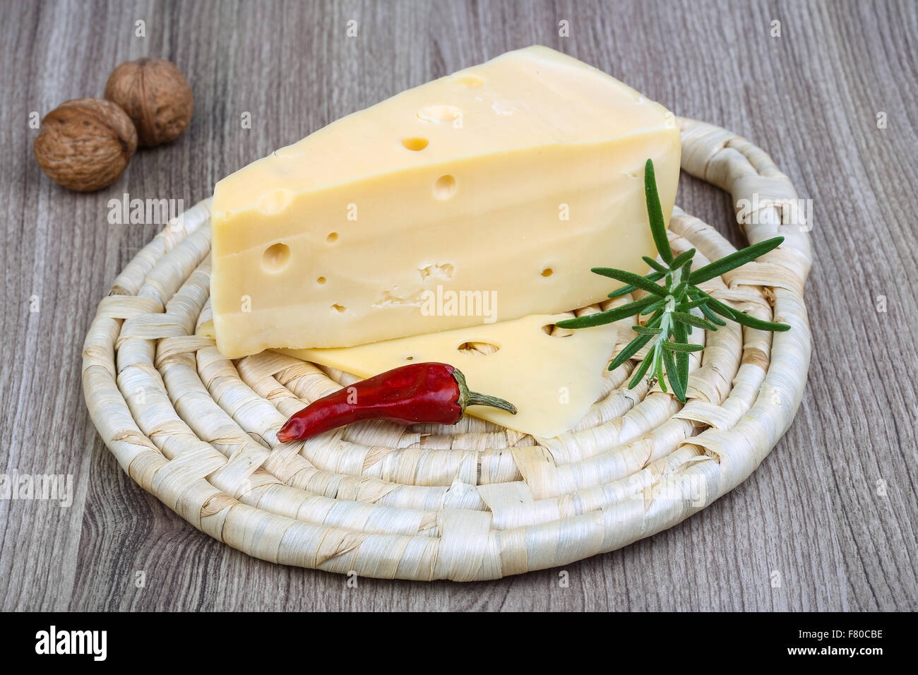 Yellow young cheese with pepper, rosemary and walnuts Stock Photo - Alamy