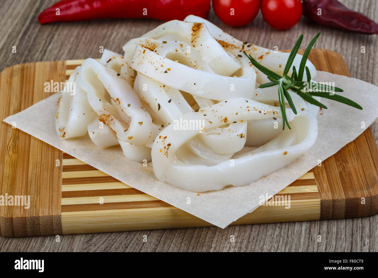 Raw squid rings with herbs - ready for cooking Stock Photo - Alamy