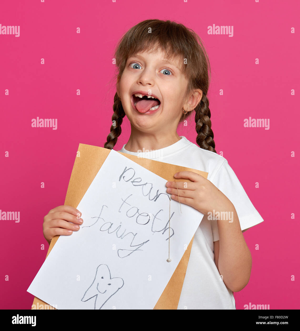 lost tooth girl portrait, studio shoot on pink background Stock Photo ...