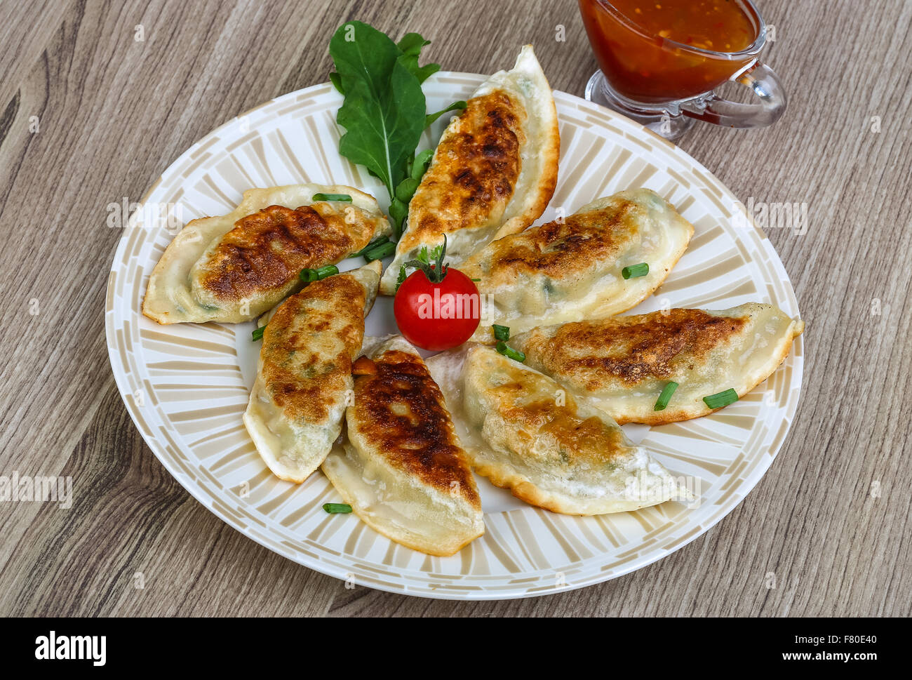 Japanese cousine - Gyoza served green onion and cherry tomato Stock ...
