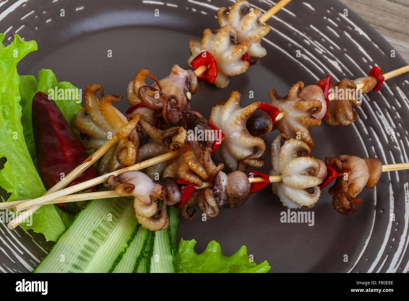 Barbecue baby octopus with bell pepper and spices Stock Photo - Alamy