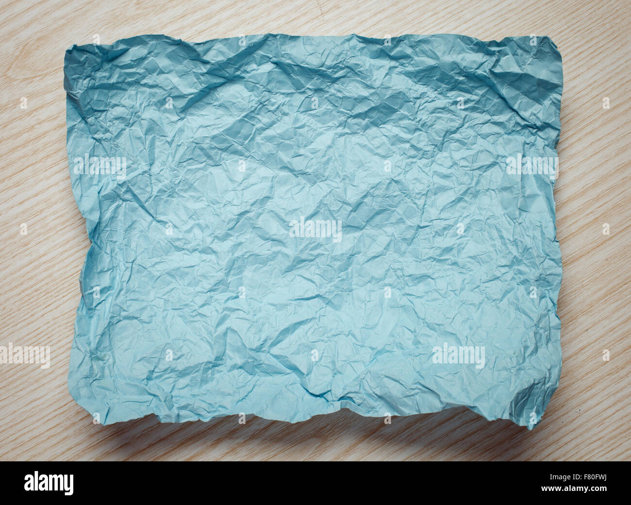 Crumpled cyan paper card on beige background, place for tex Stock Photo ...