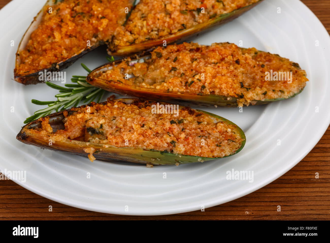 Baked mussels with bread and spices served rosemary Stock Photo - Alamy