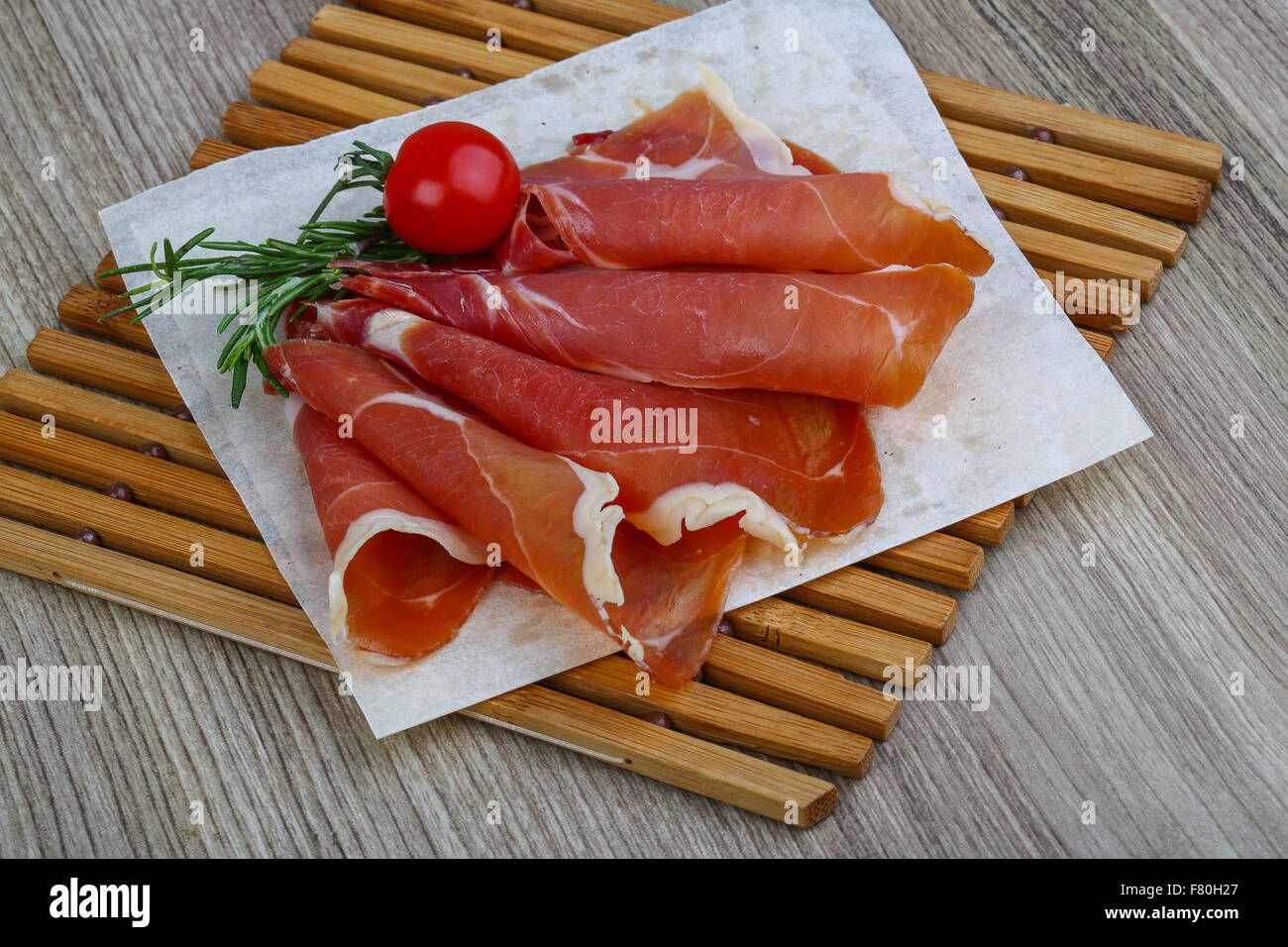 Spanish traditional snack - Jamon with tomato and rosemary Stock Photo ...