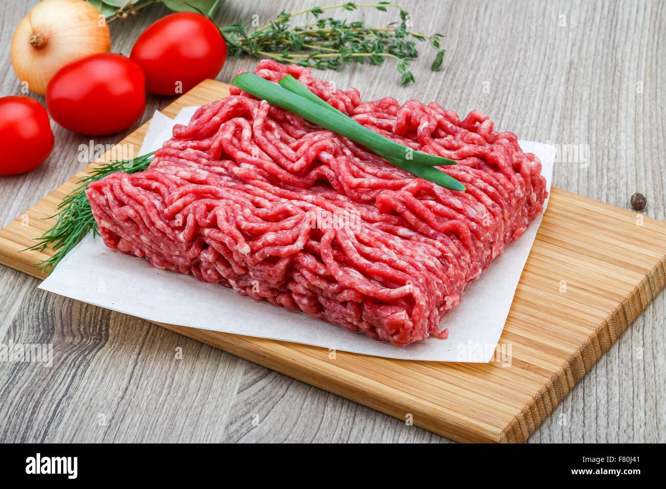 Raw minced beef meat with green oinion and dill Stock Photo - Alamy