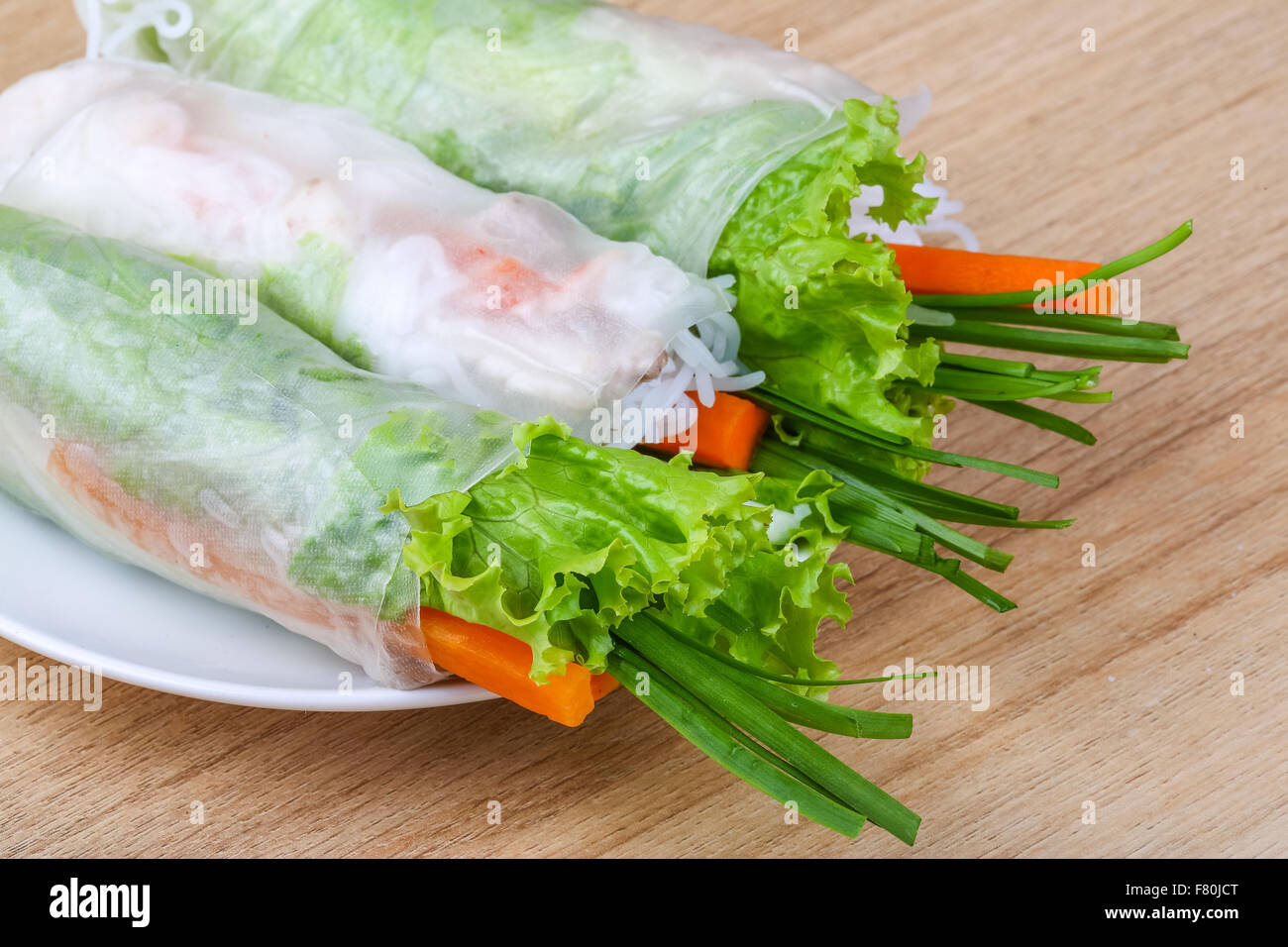 Asian traditional spring rolls on the wood background Stock Photo - Alamy