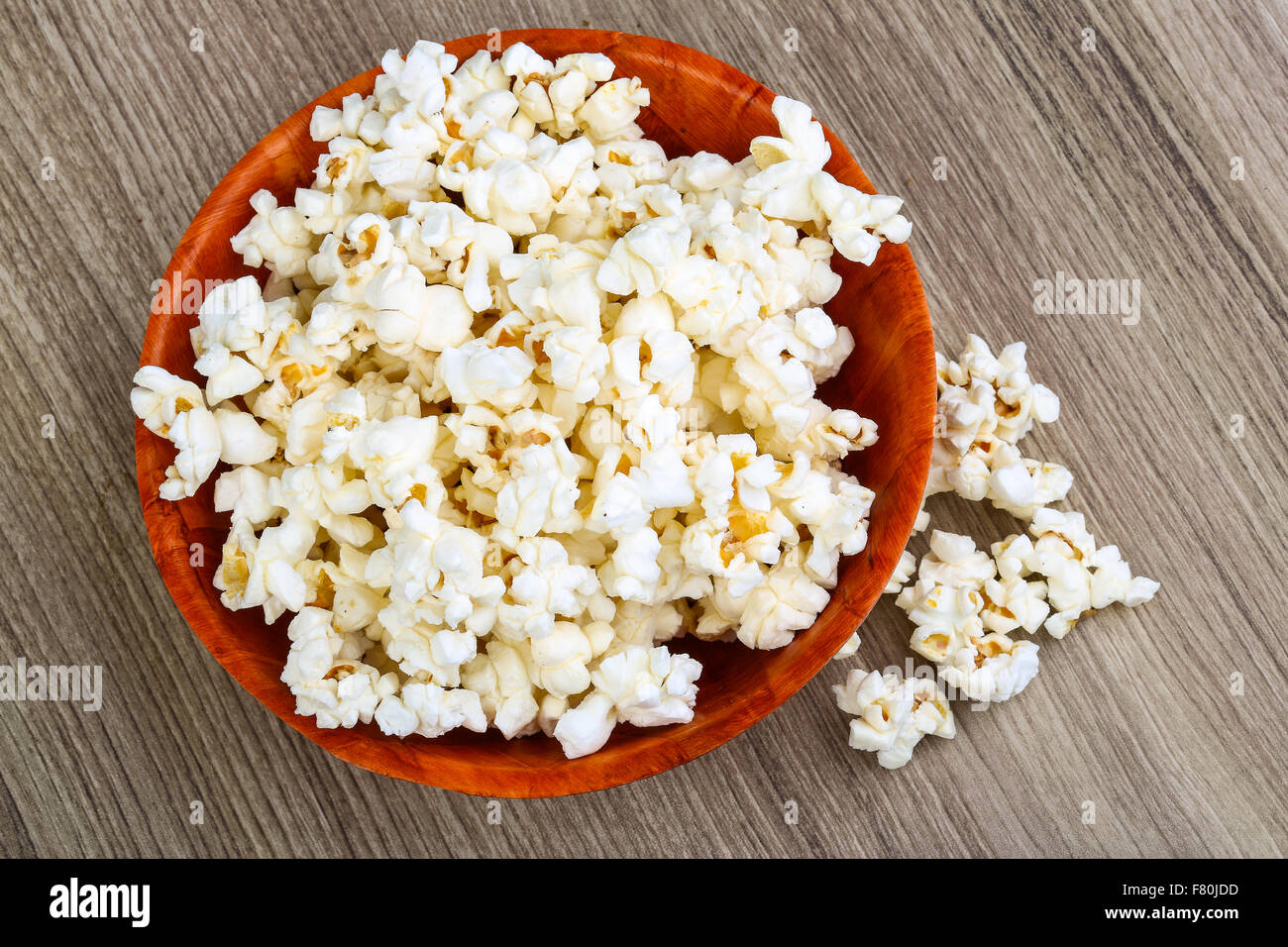 Popcorn heap in the bowl on wood background Stock Photo - Alamy